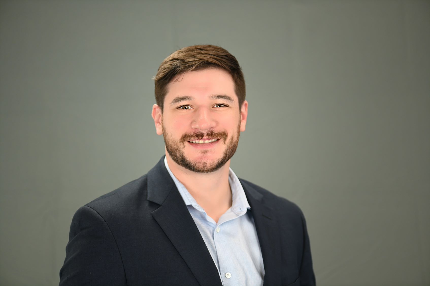Dr. Tom Holds Beaker in a Lab
